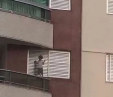 Terrifying moment toddler climbs out of window onto balcony nine storeys up
