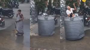 Watch how woman miraculously escapes as water tank falls directly on ...
